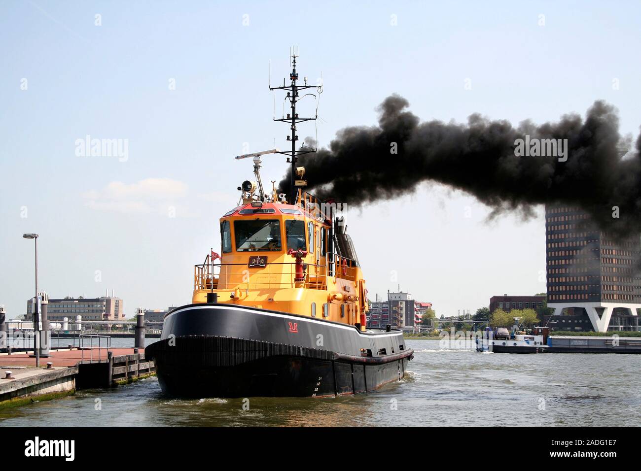 Air pollution. Smoke rising from a tugboat. Photographed in Amsterdam ...