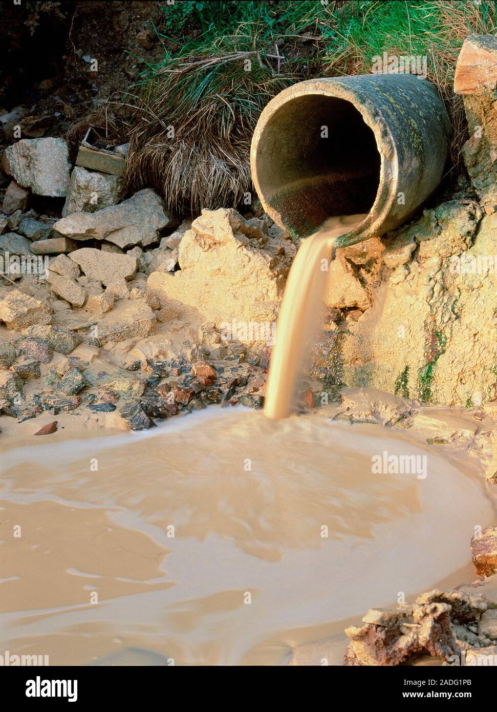 Industrial effluent. Pipeline discharging yellow liquid industrial ...