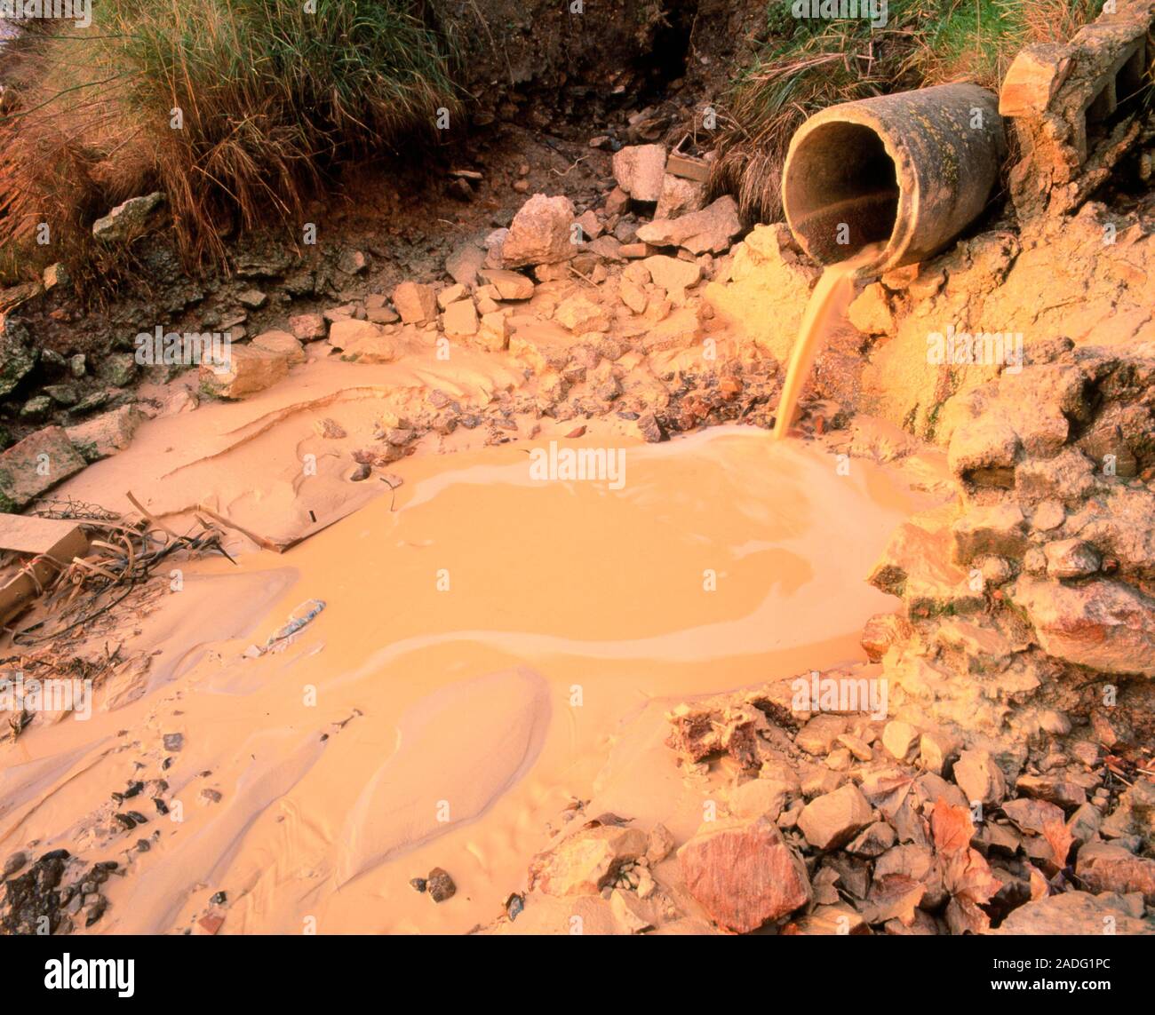 Industrial effluent. Pipeline discharging yellow liquid industrial ...