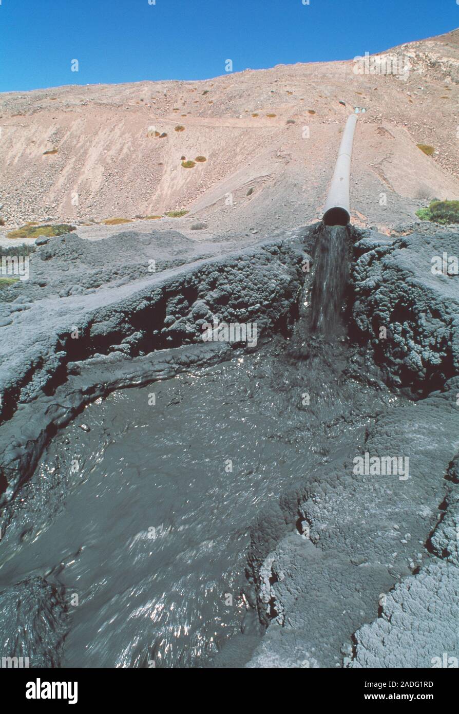 Mining pollution. Sludge flowing from a pipe. Water has been used to ...