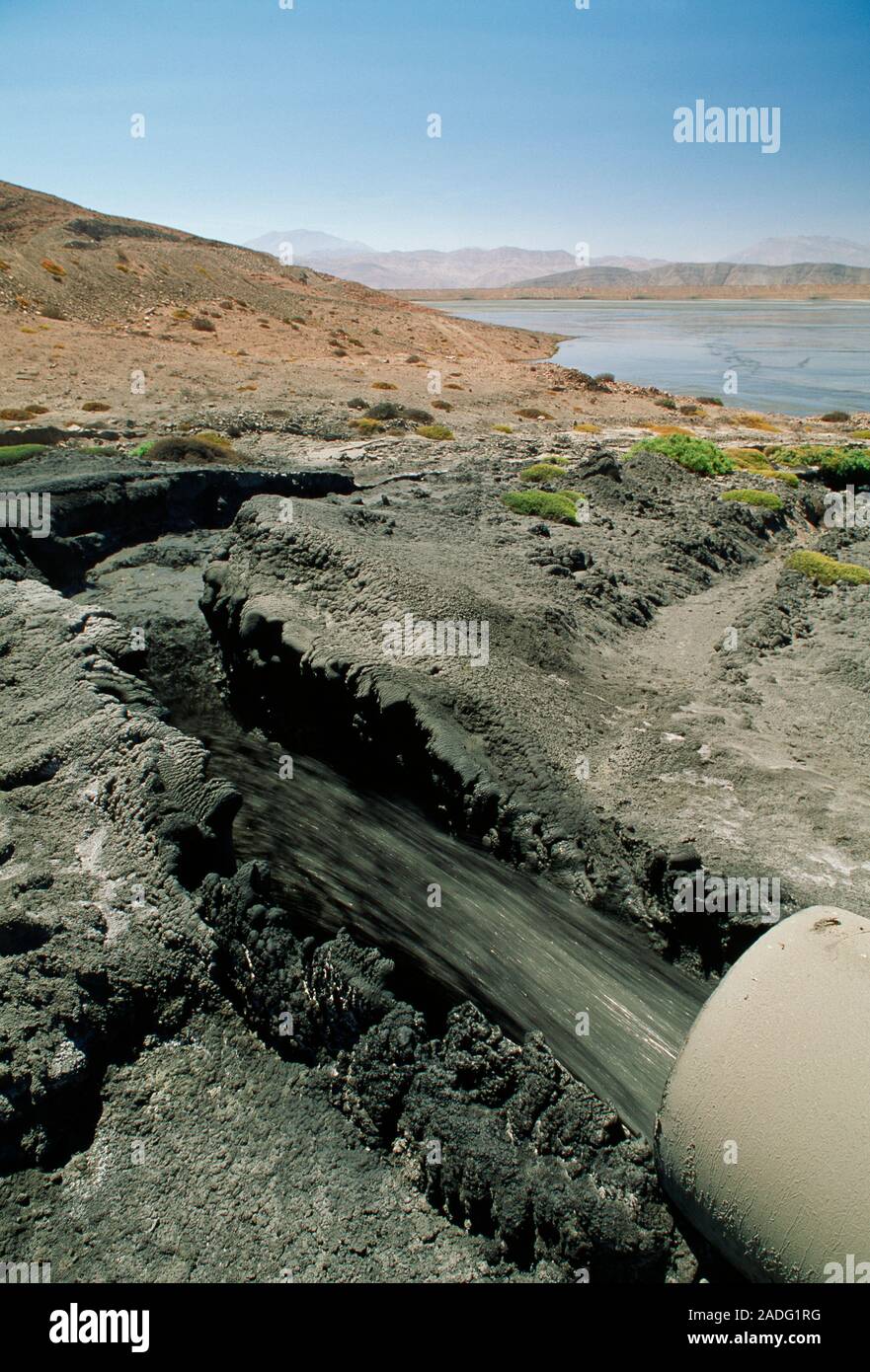 Mining pollution. Sludge flowing from a pipe. Water has been used to ...