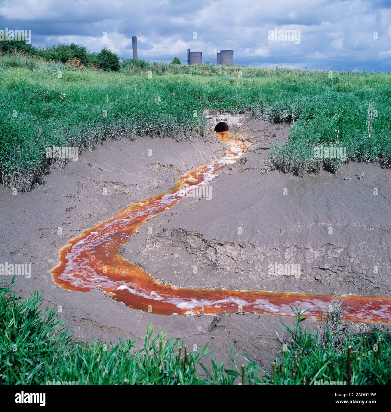 Water pollution. Outflow pipe from a chemical factory releasing ...