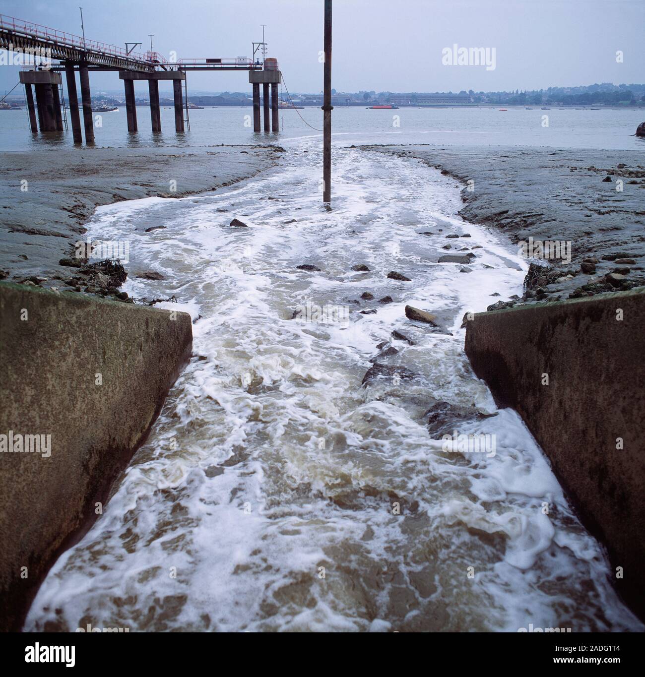 Water pollution. Sewage outflow into a river. Photographed on the ...