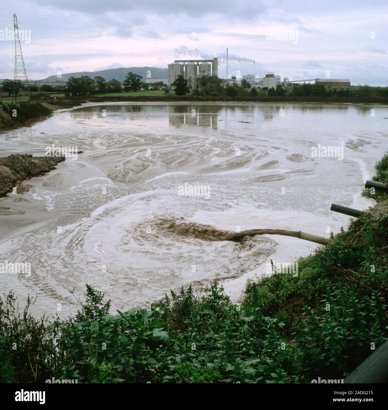 Industrial pollution. Effluent from a sugar mill (top) being discharged ...