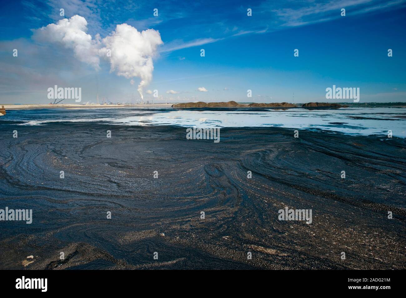 Oil industry pollution. Tailings settling pond with residual crude oil ...