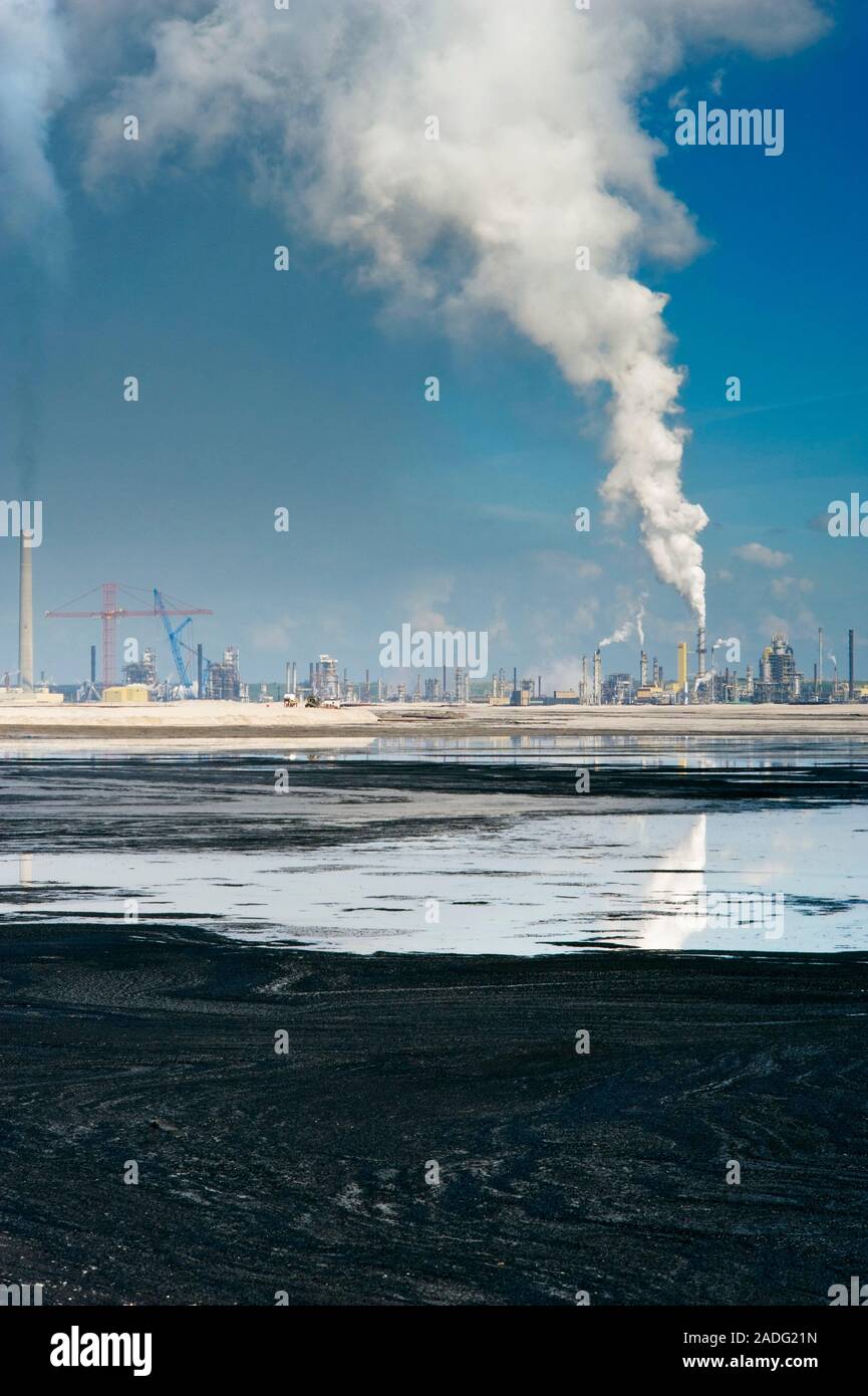 Oil industry pollution. Tailings settling pond with residual crude oil ...