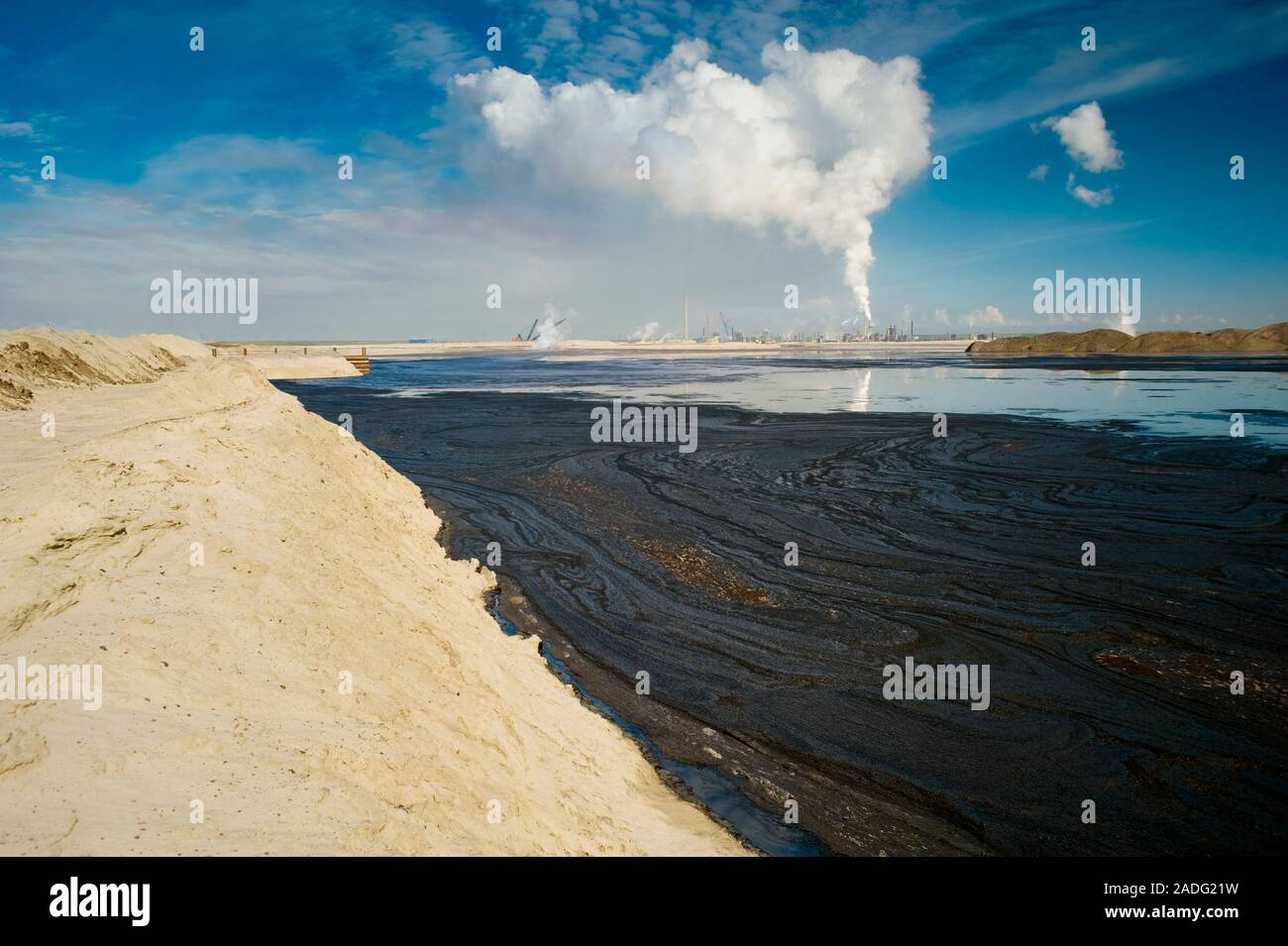 Oil industry pollution. Tailings settling pond with residual crude oil ...
