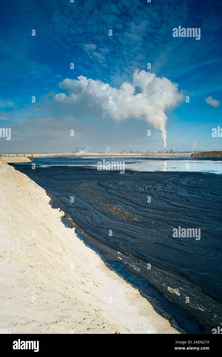Oil industry pollution. Tailings settling pond with residual crude oil ...