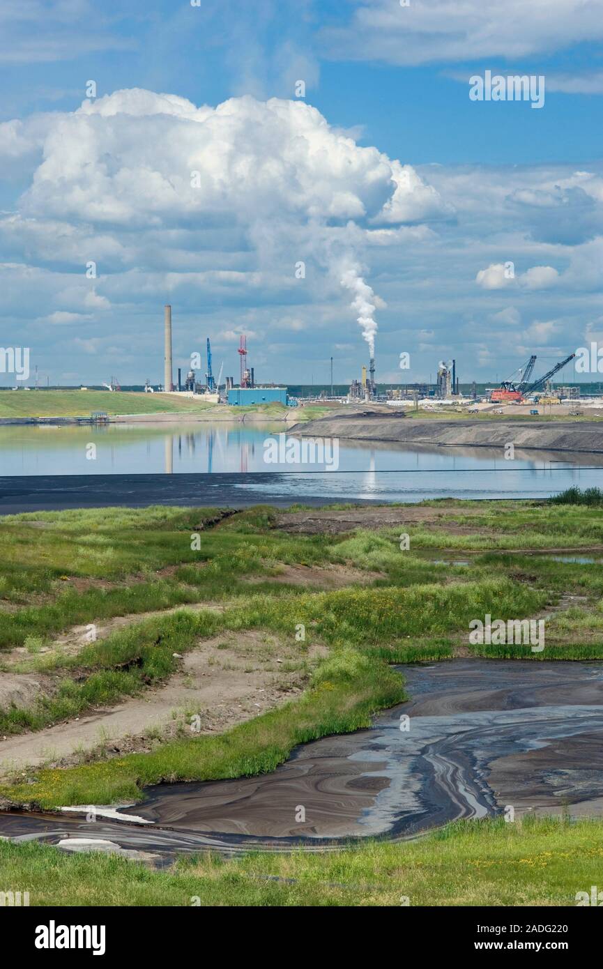 Oil industry pollution. Tailings settling pond with residual crude oil ...