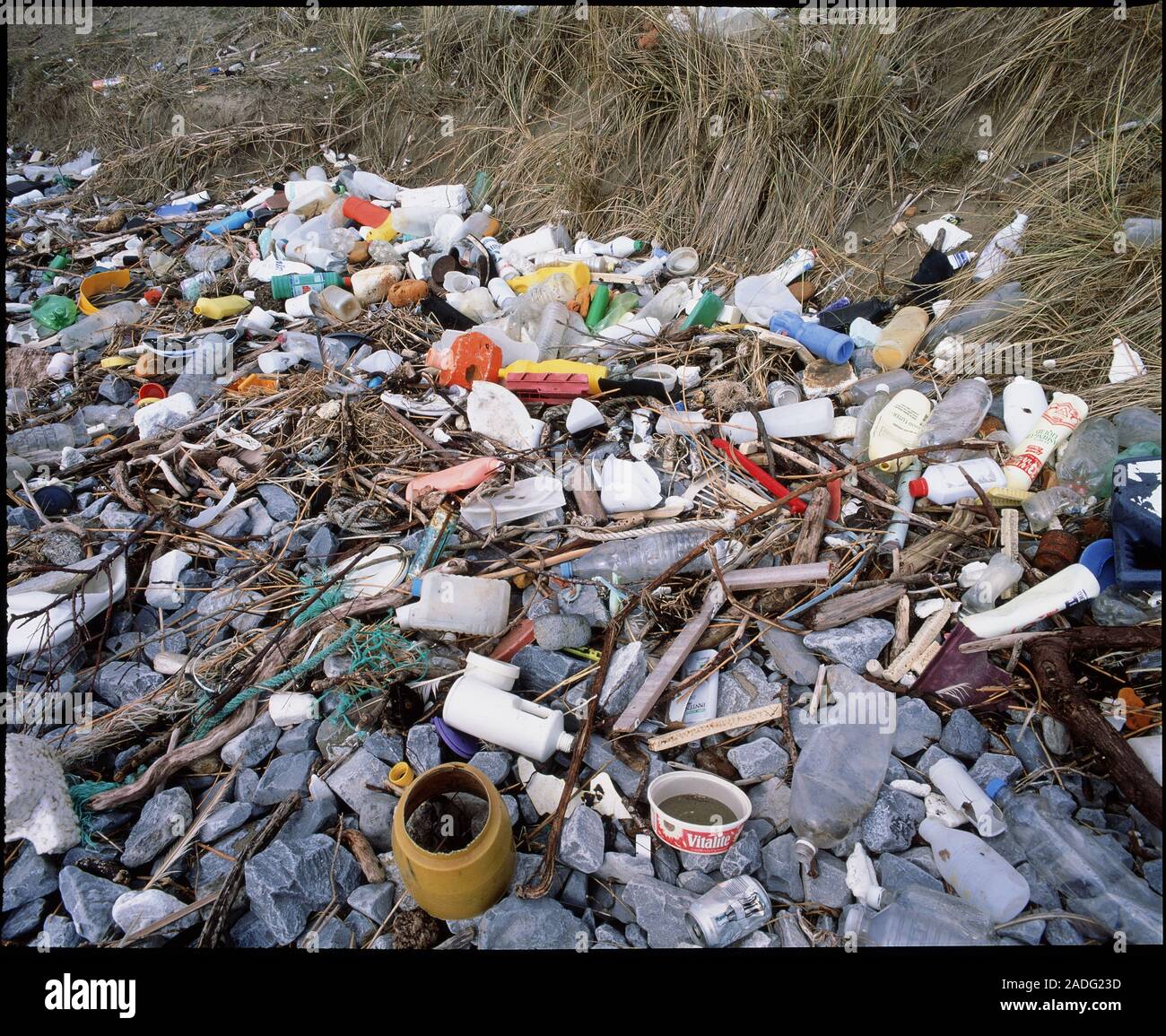 Marine pollution. Flotsam and jetsam, mainly plastic bottles, washed up ...