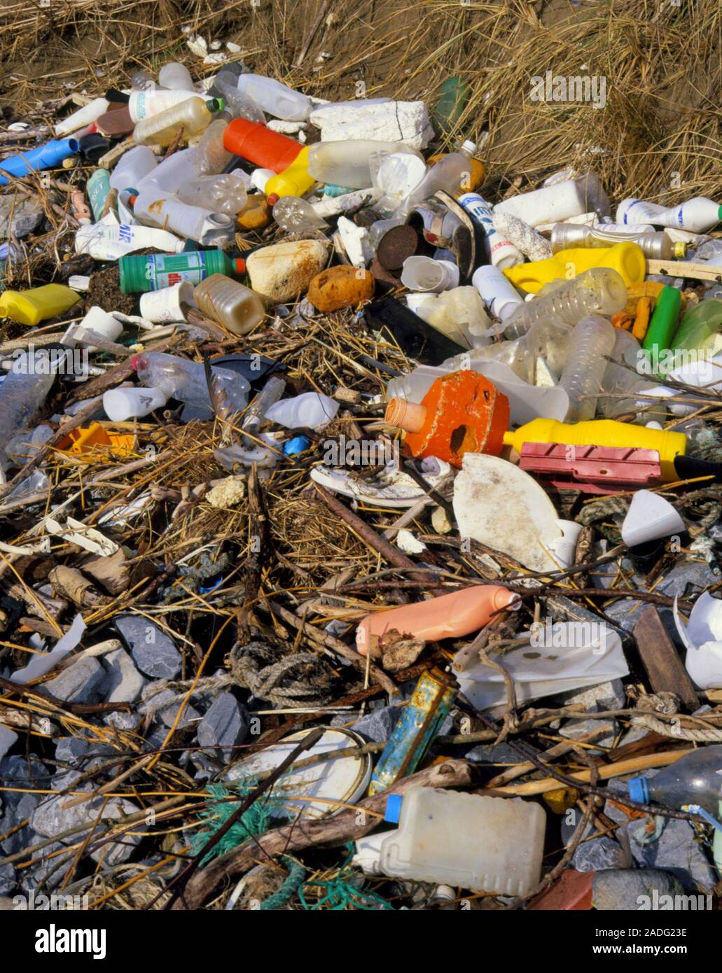 Marine pollution. Flotsam and jetsam, mainly plastic bottles, washed up ...