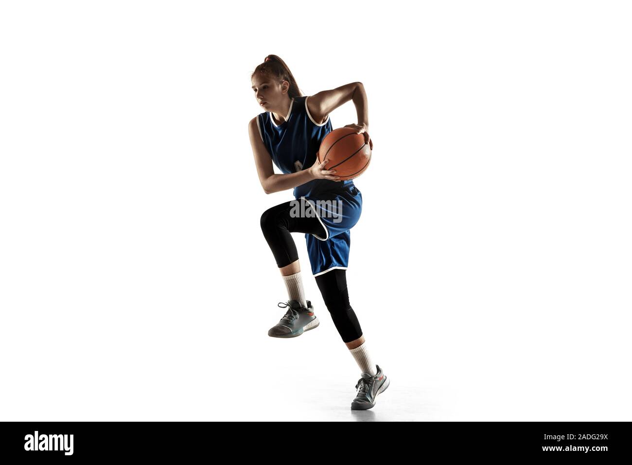 Young caucasian female basketball player of team in action, motion in ...