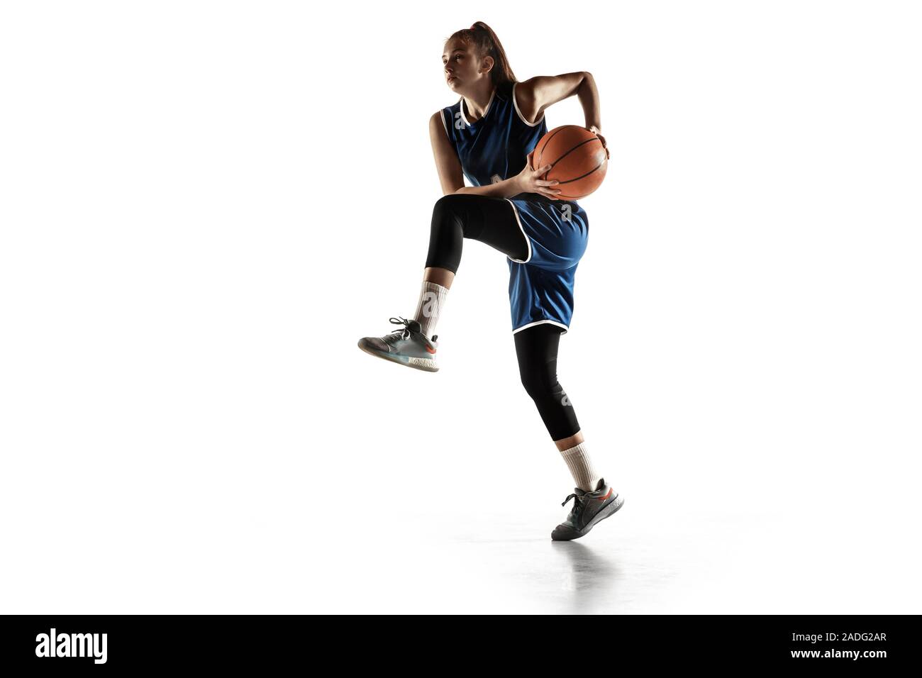 Young caucasian female basketball player of team in action, motion in ...