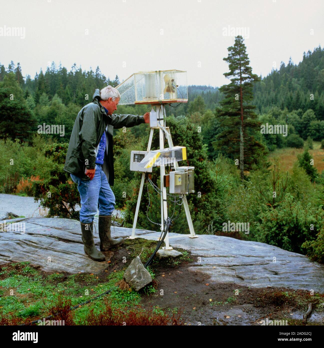 Monitoring atmospheric pollution. A researcher tending an 'active fog ...