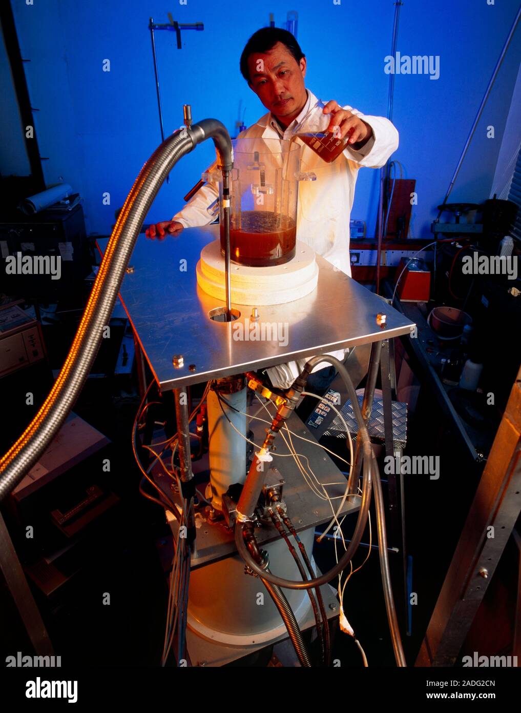 Decontamination of toxic waste using bacteria. A technician loading a ...