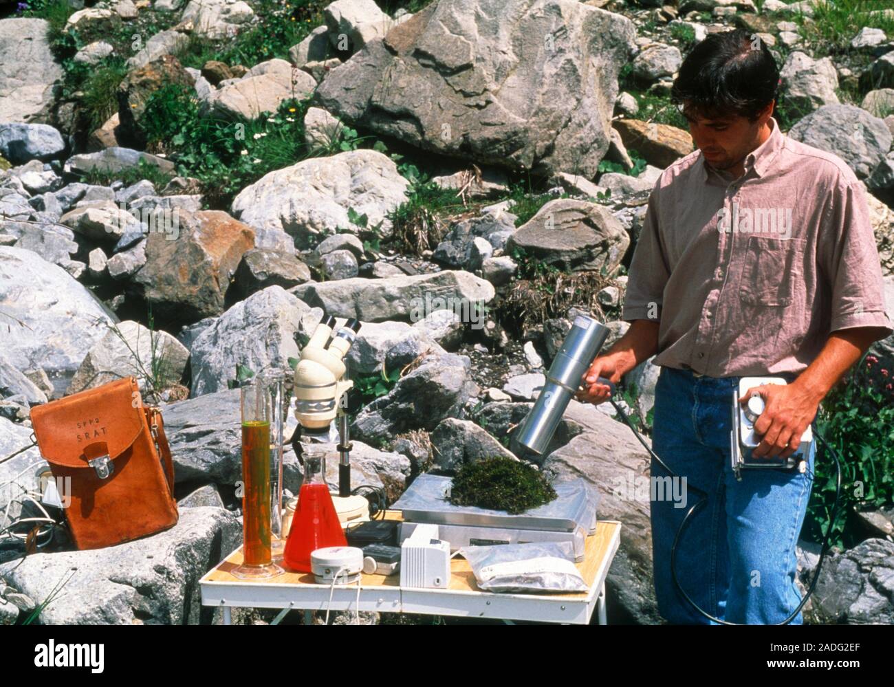 Radioactivity analysis. Researcher using a geiger counter to measure ... Radioactivity analysis. Researcher using a geiger counter to measure ...