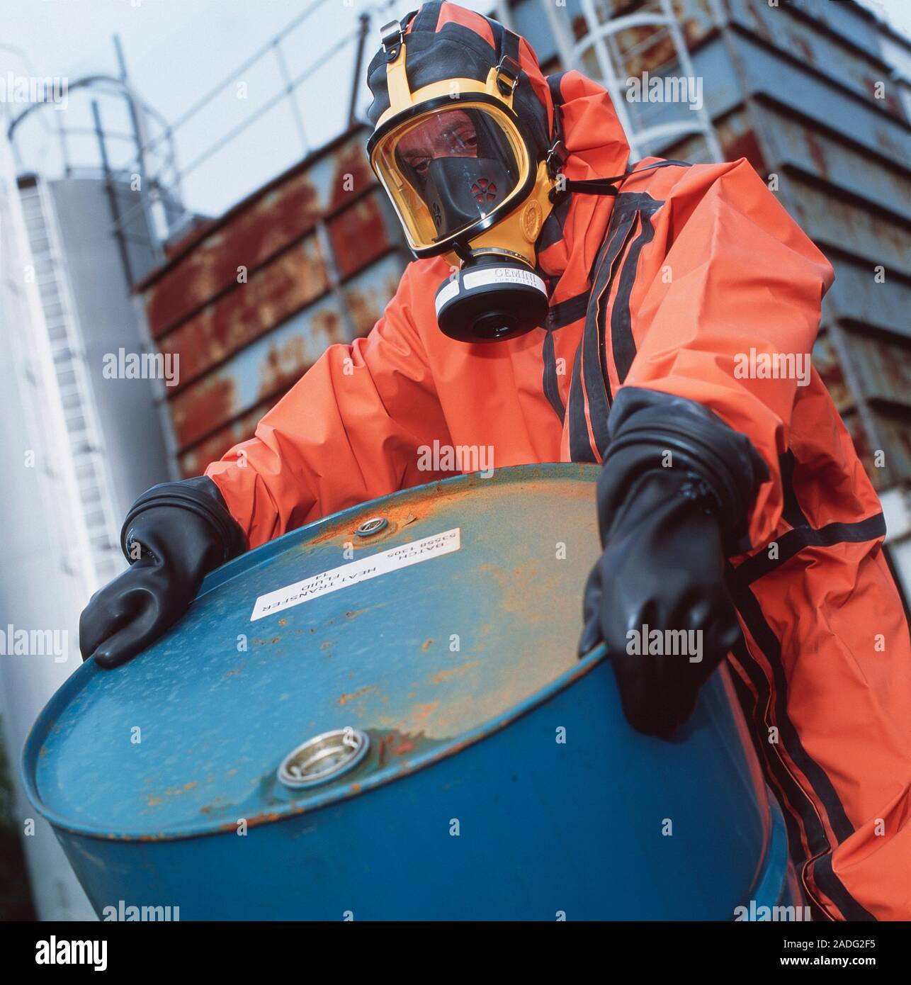 Toxic chemical treatment. Man wearing a protective suit and gas mask ...