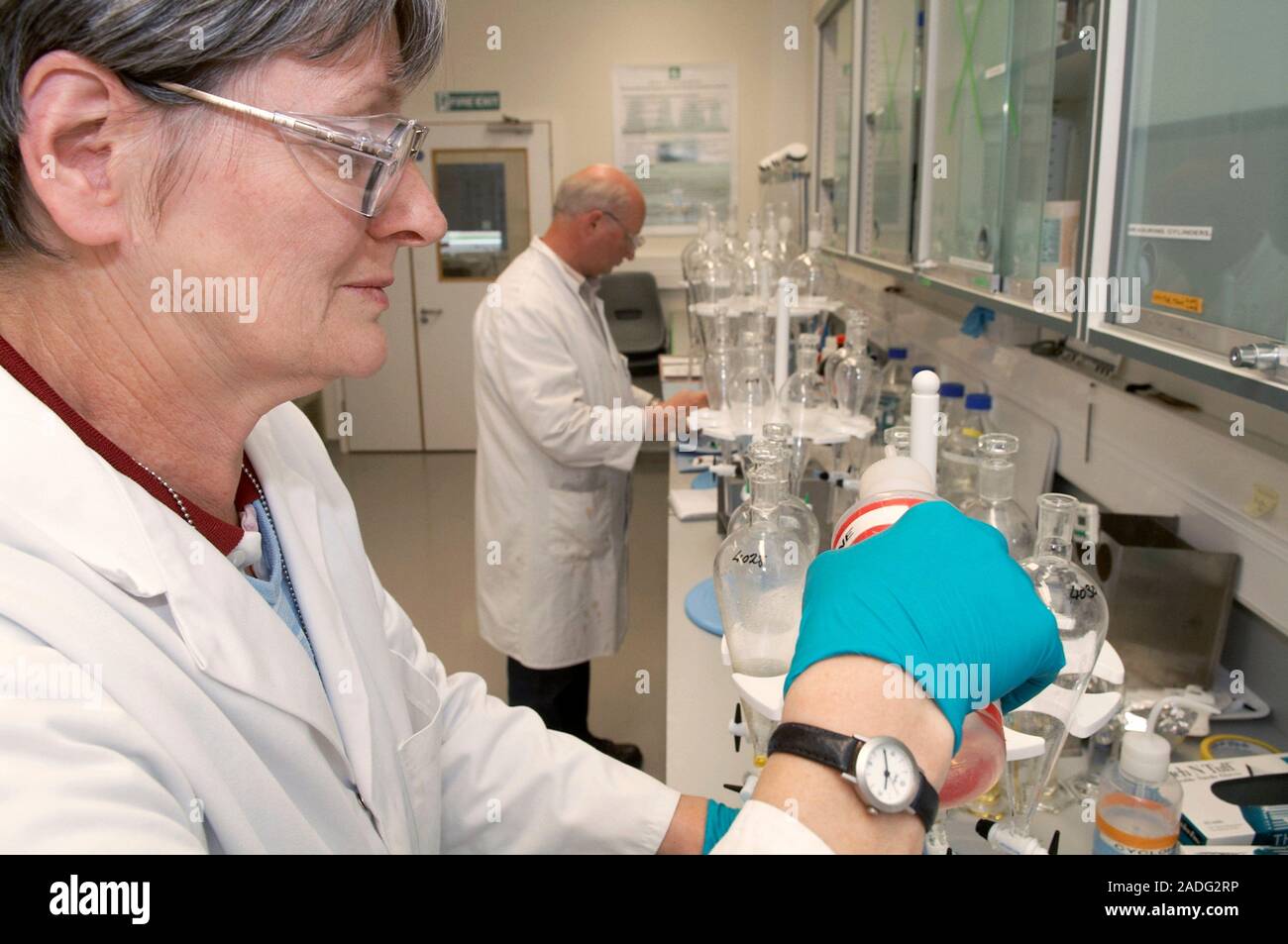 Pollution monitoring. Chemists in a research laboratory, testing ...