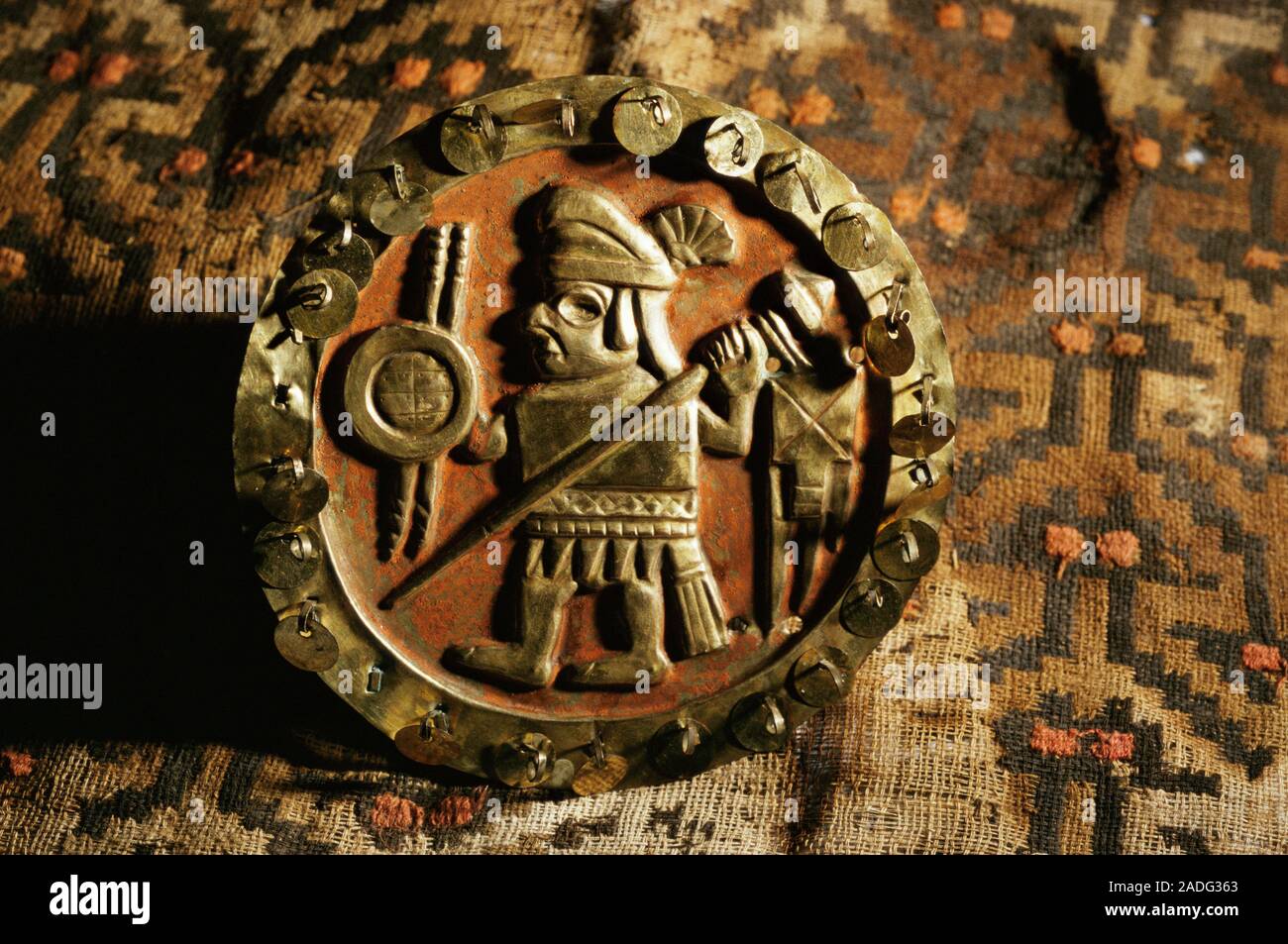 Moche ear shield. Golden ear shield made by the Moche people and worn ...