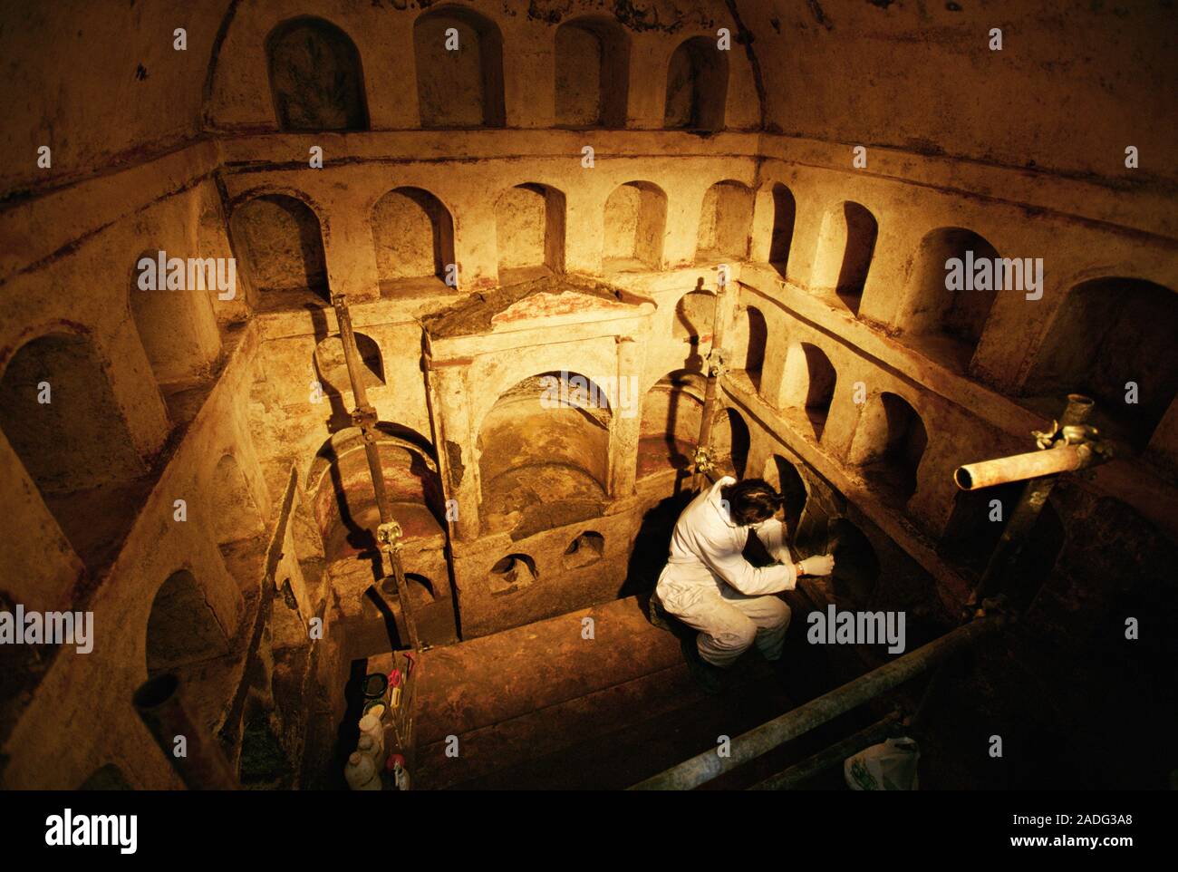 Roman burial house. Restorer working inside a Roman burial site. This ...