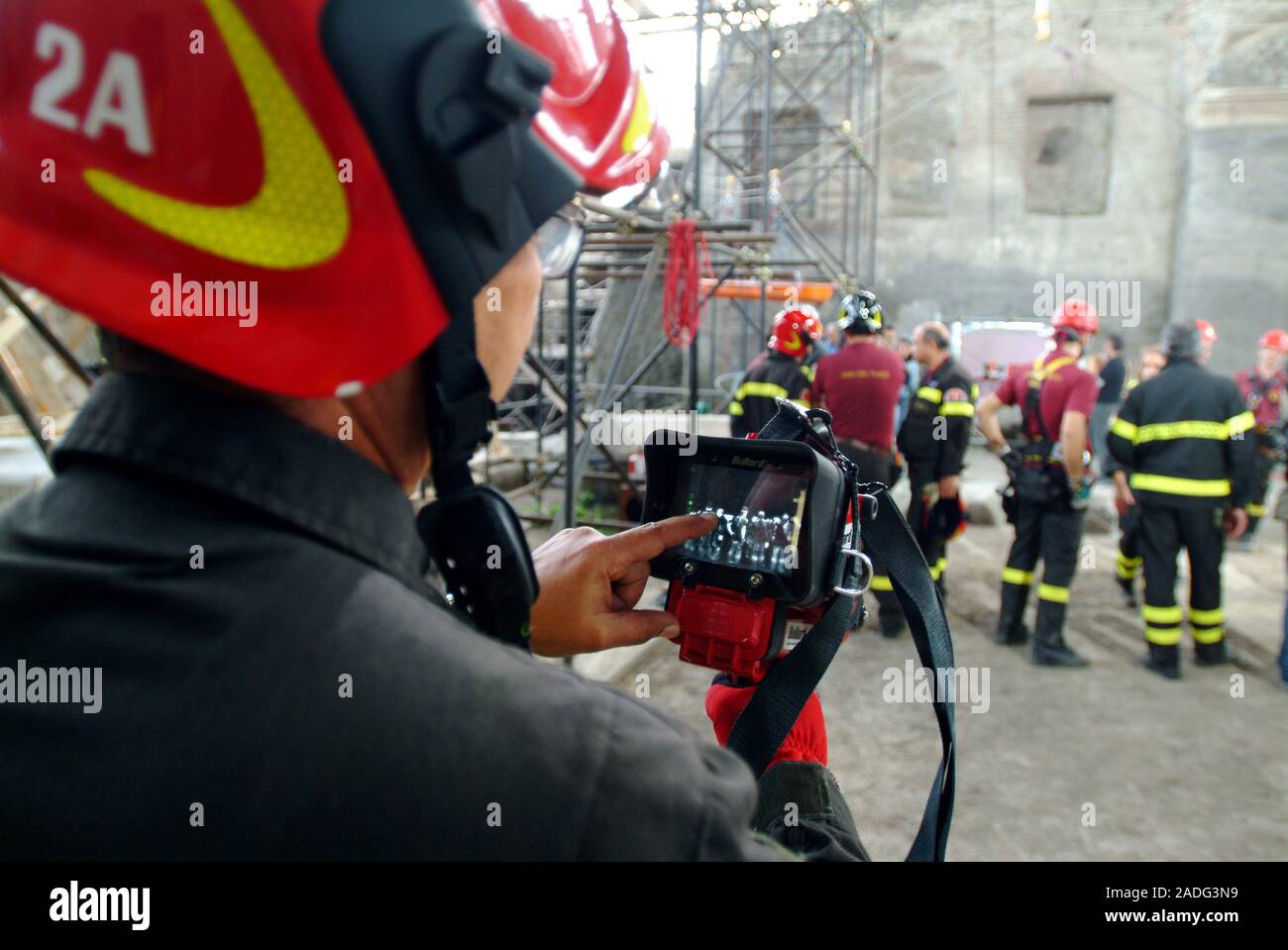 Preservation of a Roman villa. Fireman using a thermal camera to ...