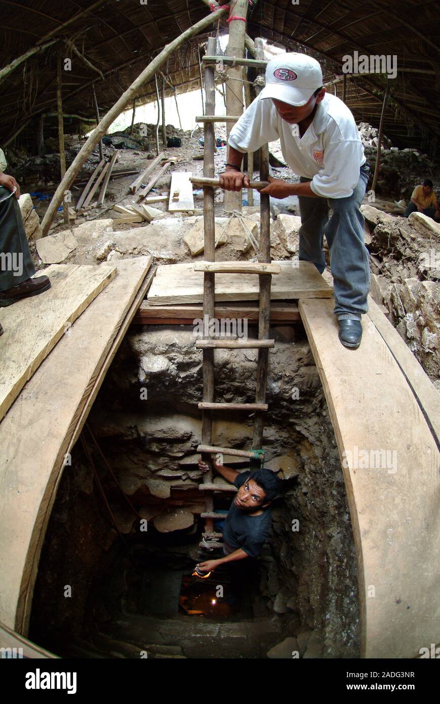 Excavating a Mayan ruin. Archaeologists exploring hidden stairs beneath ...