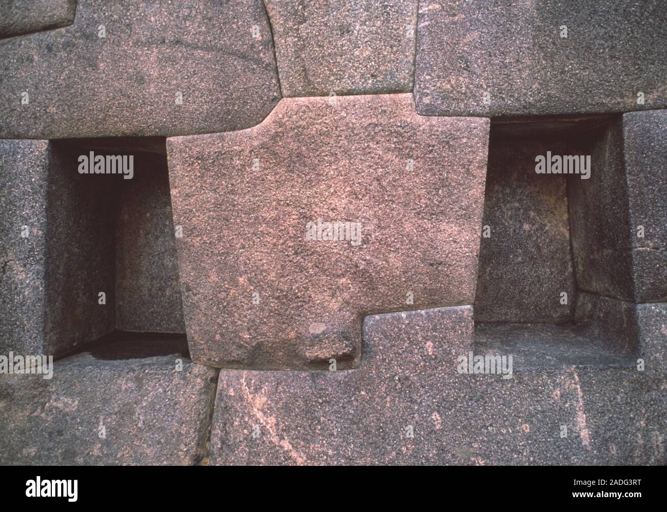 Inca architecture. Holes in a stone wall that may have been used by the ...
