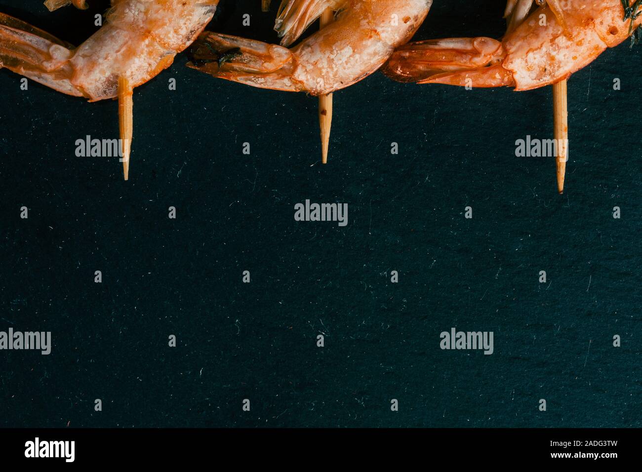 Three sharp wooden picks with fried prawns Stock Photo - Alamy