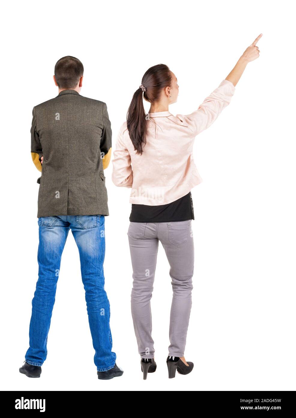 Back view of a stylish couple pointing. beautiful friendly girl and guy ...