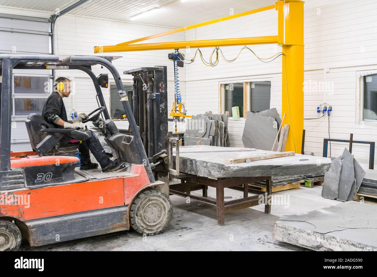 Male working with slates, flat rock, flat stone, from quarry in Pæska ...