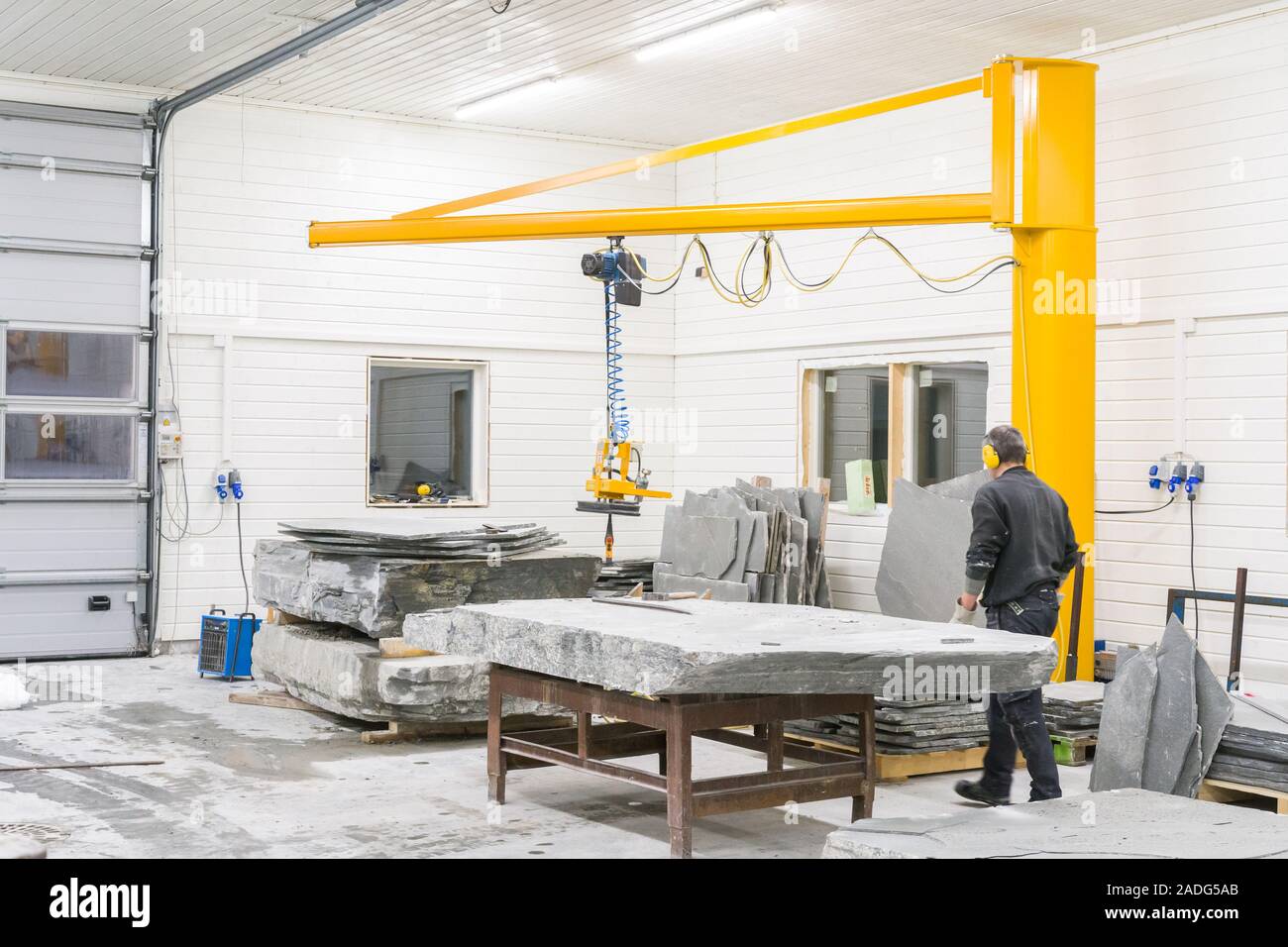 Male working with slates, flat rock, flat stone, from quarry in Pæska ...