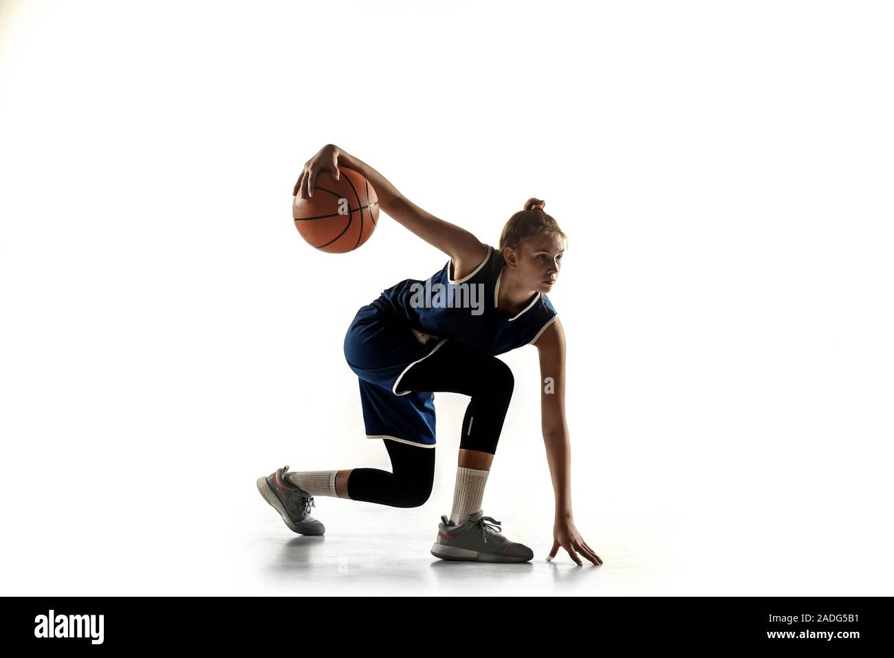 Young caucasian female basketball player of team in action, motion in ...