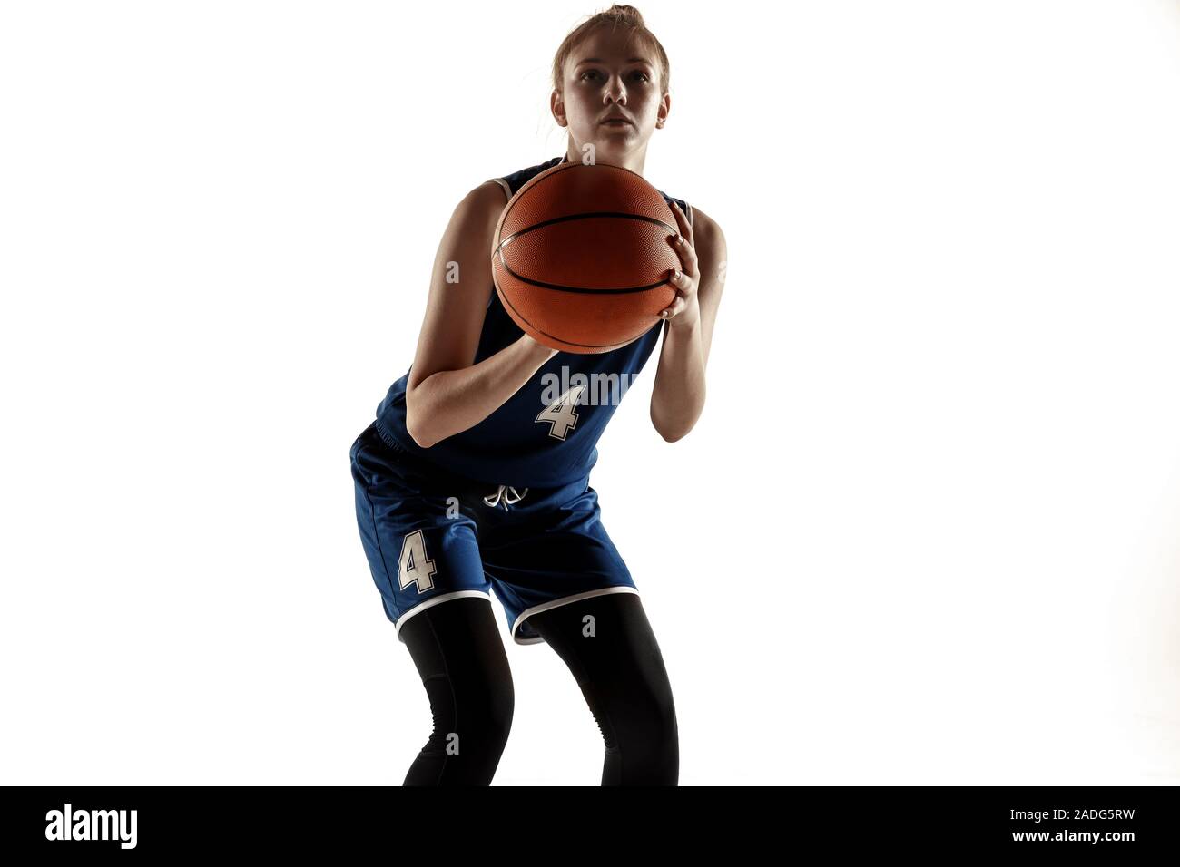 Young caucasian female basketball player of team in action, motion in ...