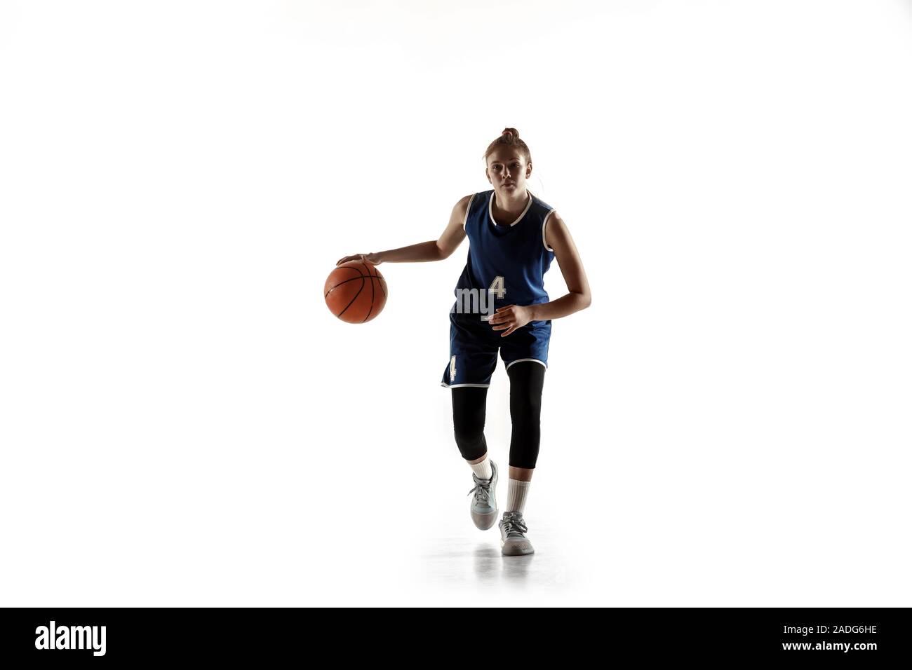 Young caucasian female basketball player of team in action, motion in ...