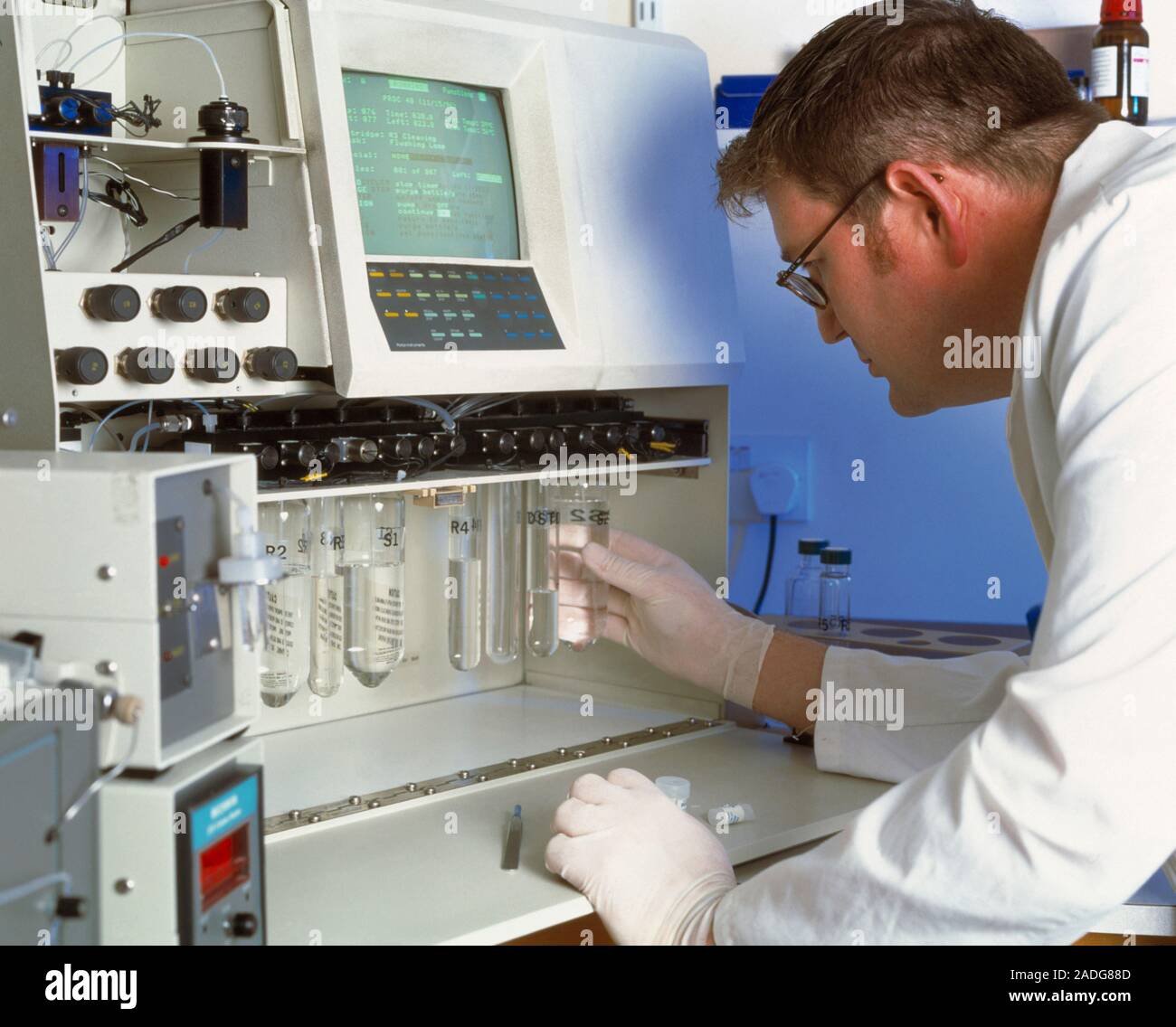 Protein analysis. Technician preparing to use an automated ...