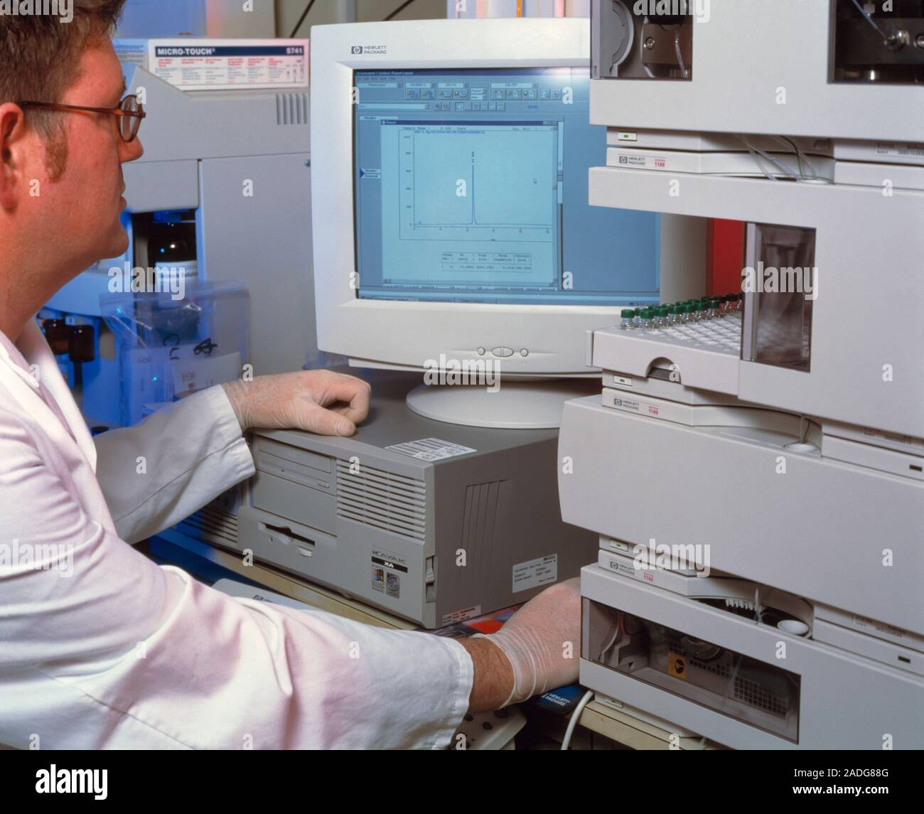 Protein research. Technician using an HPLC (high-performance liquid ...