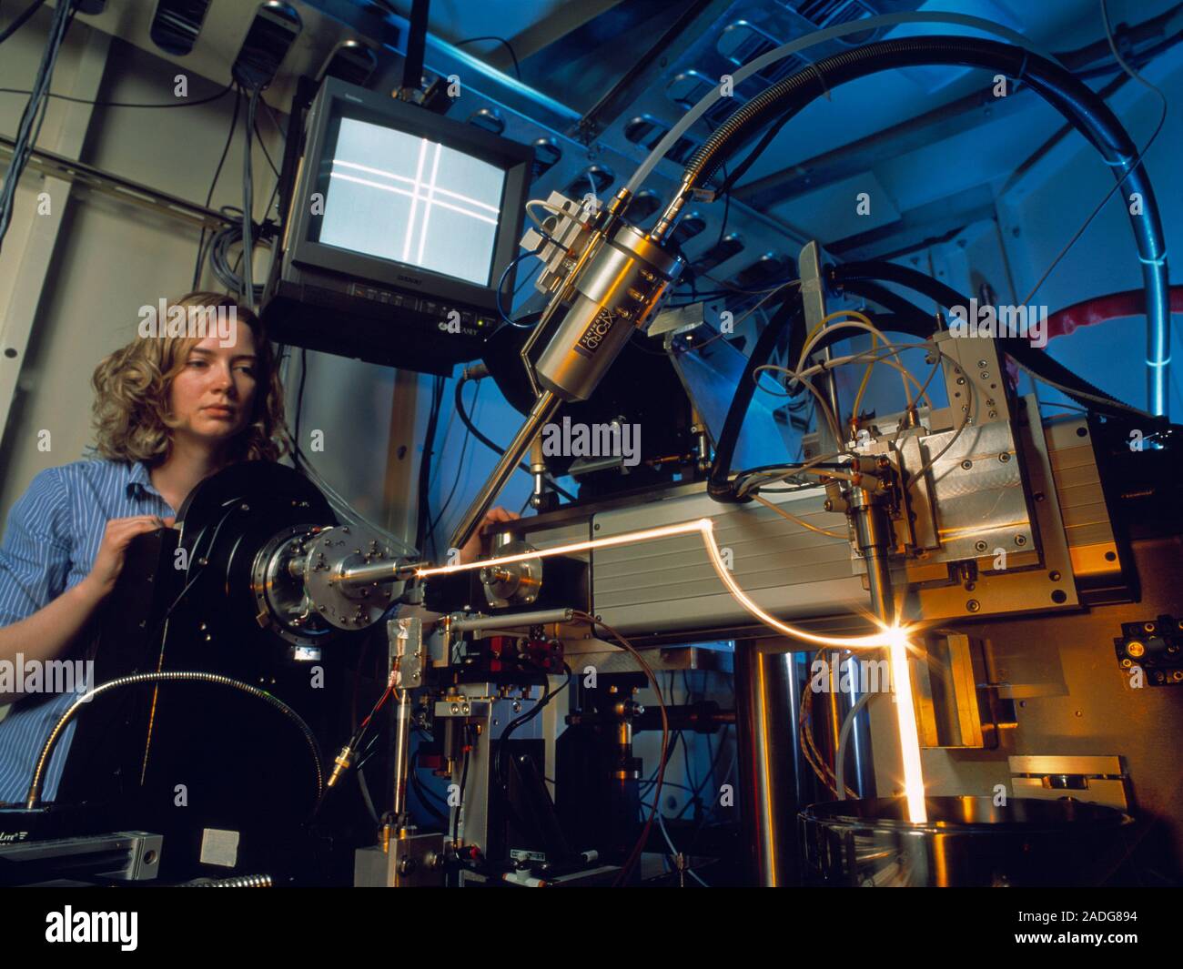 Proteomics. Researcher with an automatic X-ray crystallography machine ...