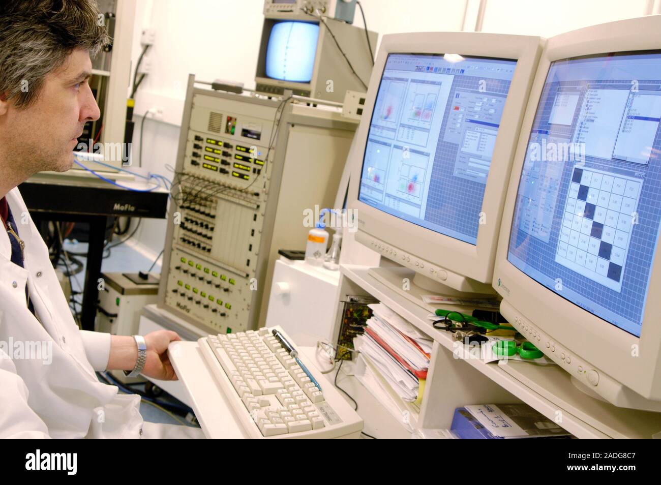 Biological research. Researcher operating a high-speed centrifuge (cell ...