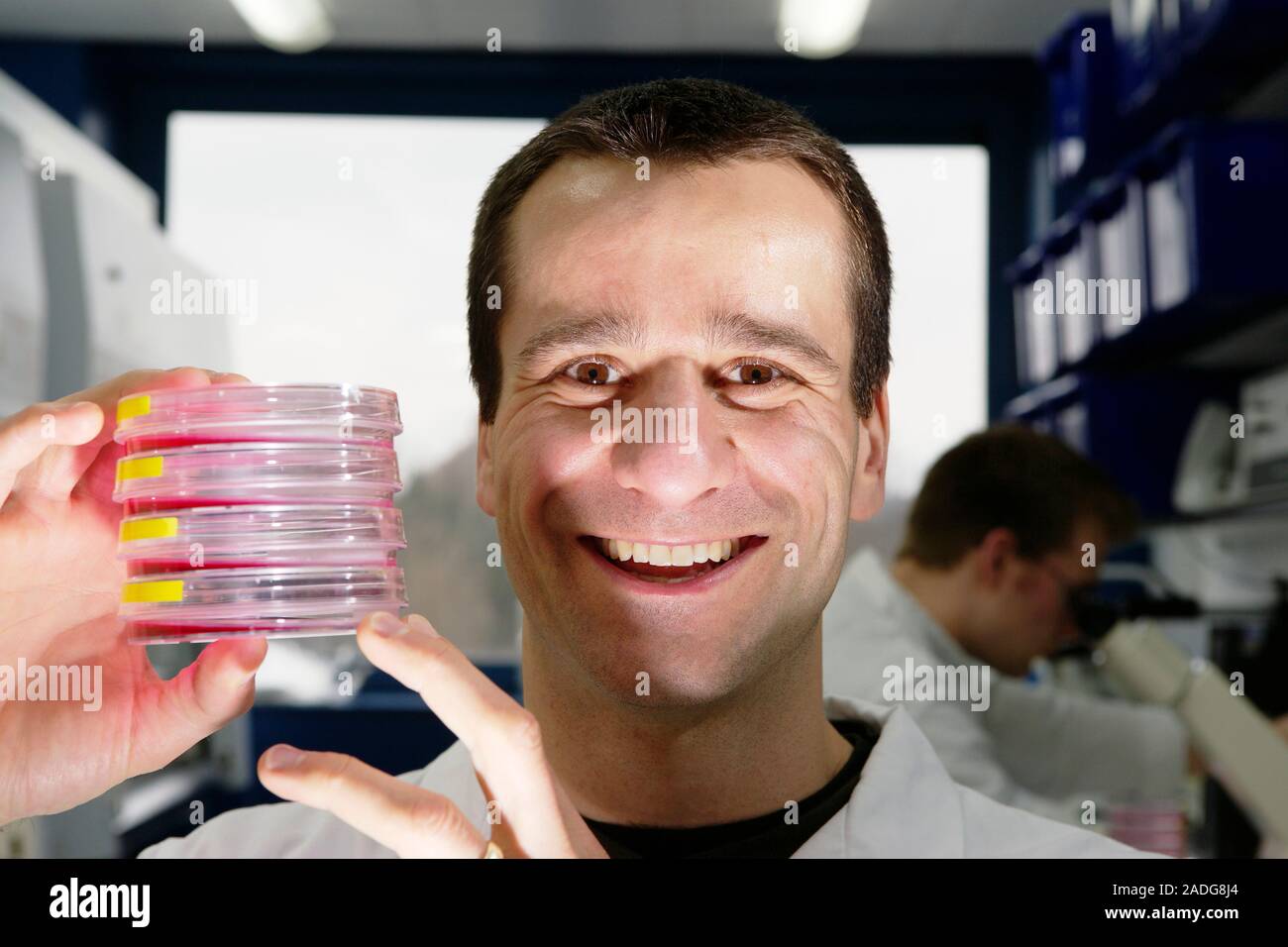 MODEL RELEASED. Molecular physiology research. Dr Keith Barr holding ...