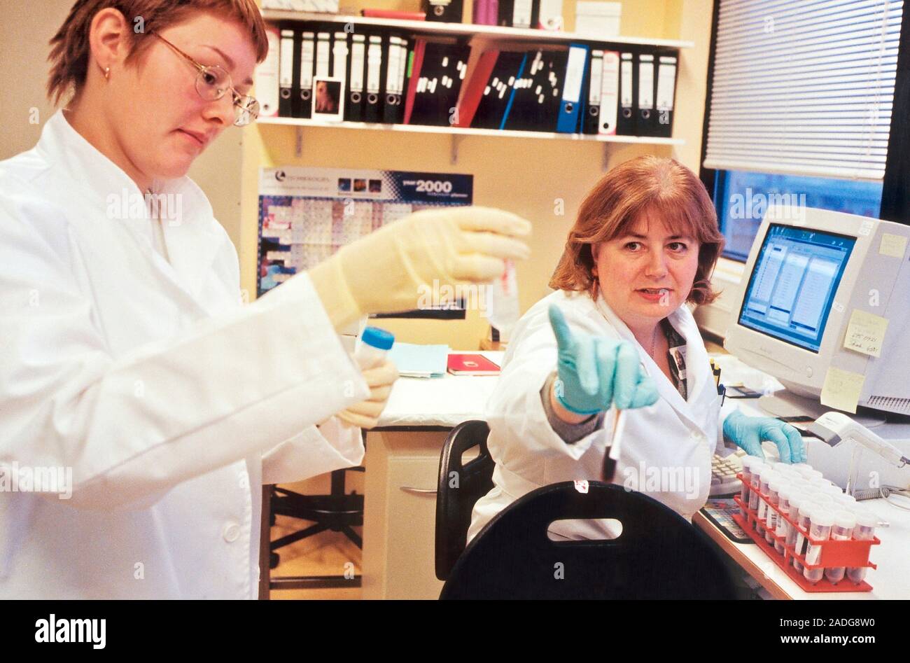 Biological research. Researchers handling samples in a laboratory while ...