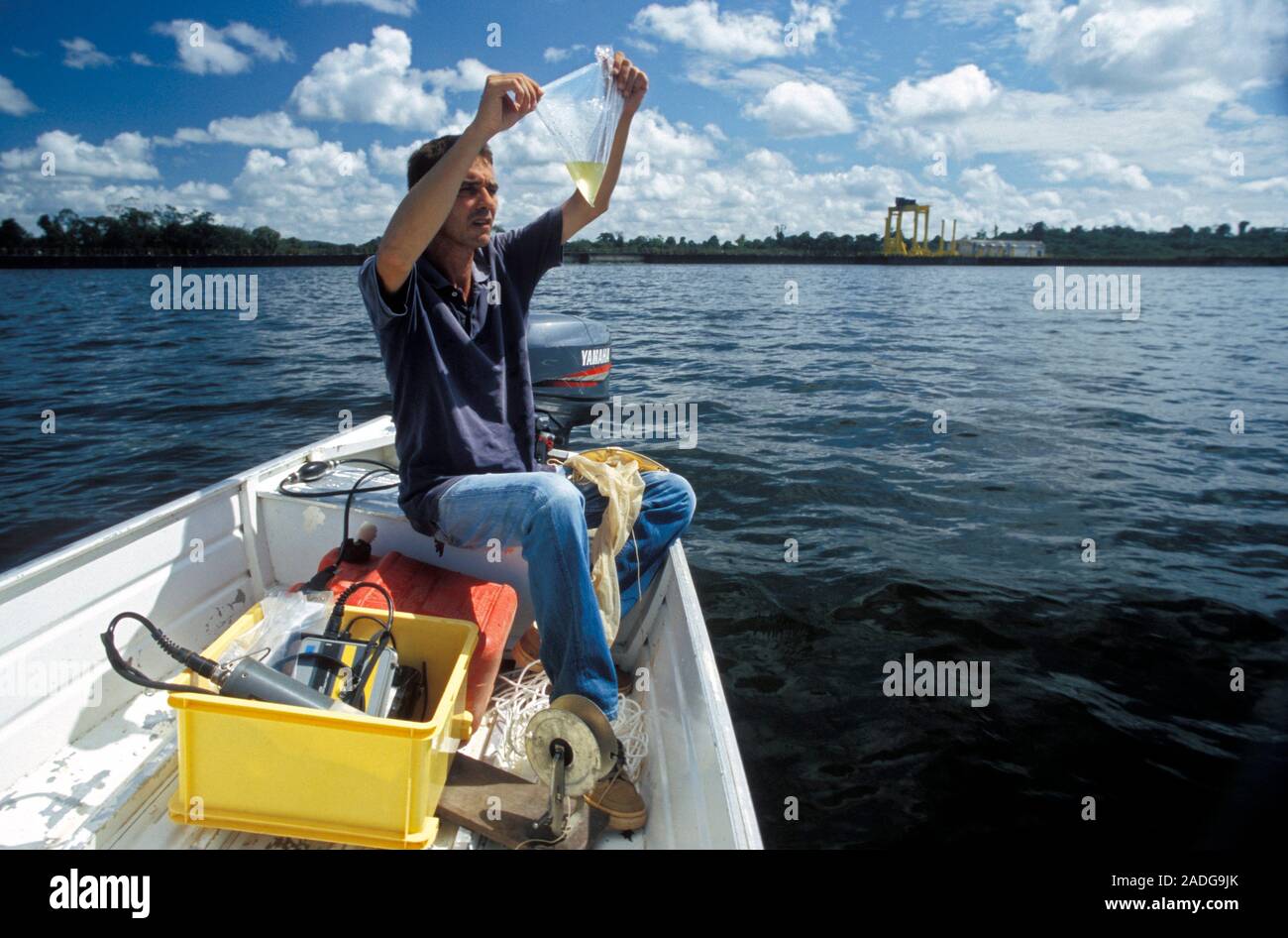 Hydrobiology research. Scientist in a boat monitoring a water reservoir ...