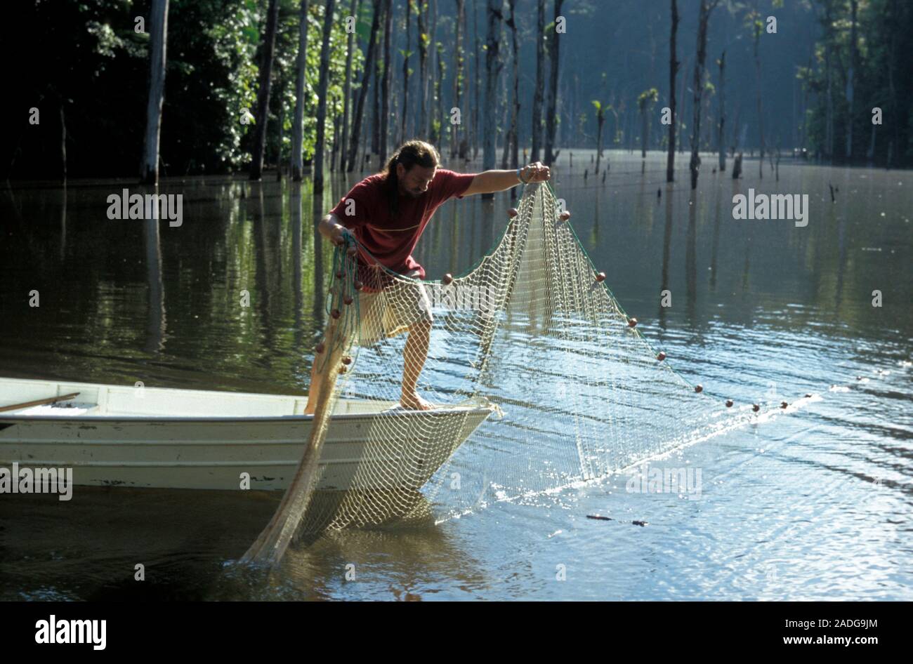 Hydrobiology and pollution research. Scientist in a boat monitoring a ...