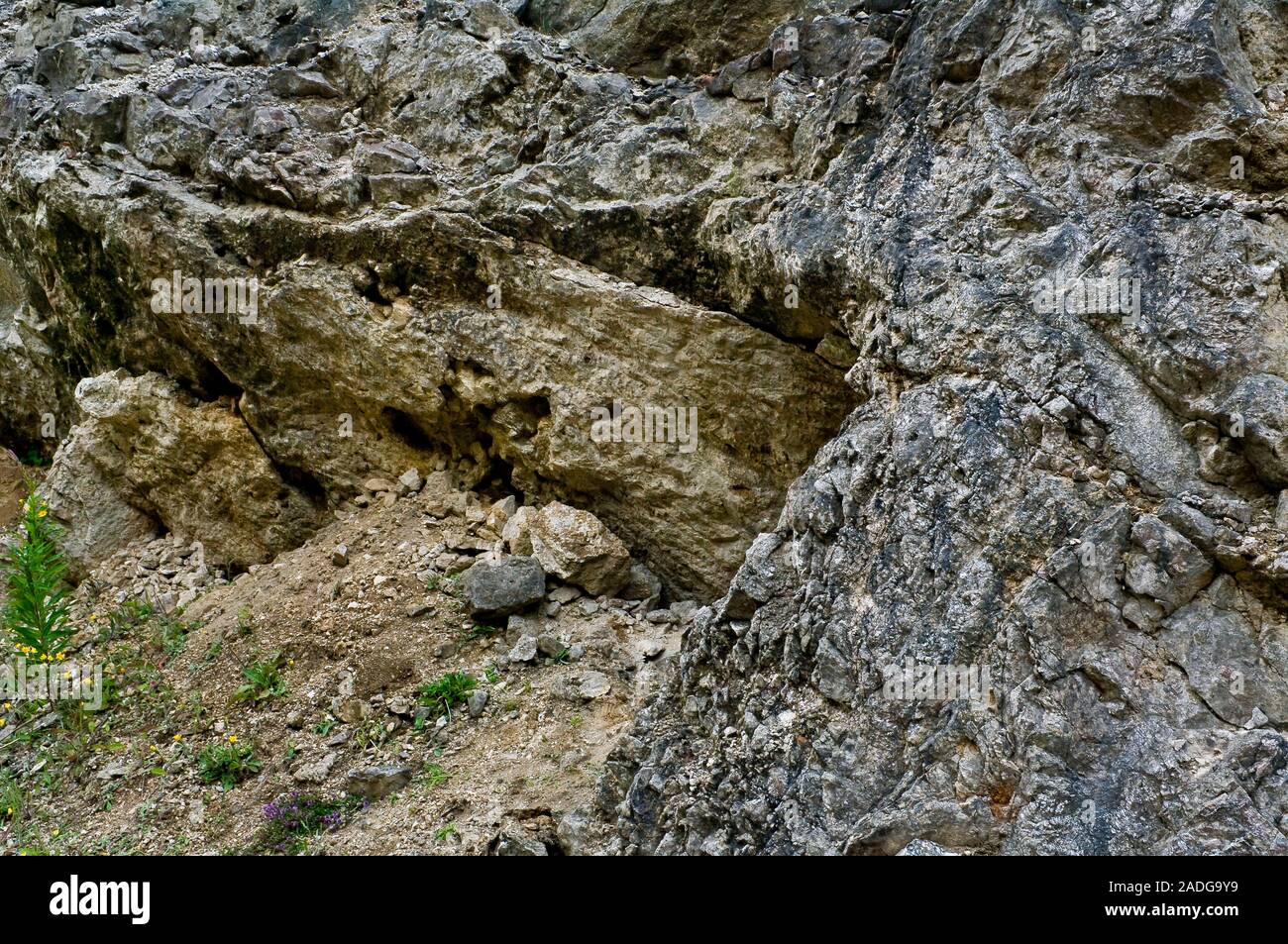Shattered limestone and miners' pickwork near a mine entrance at a ...