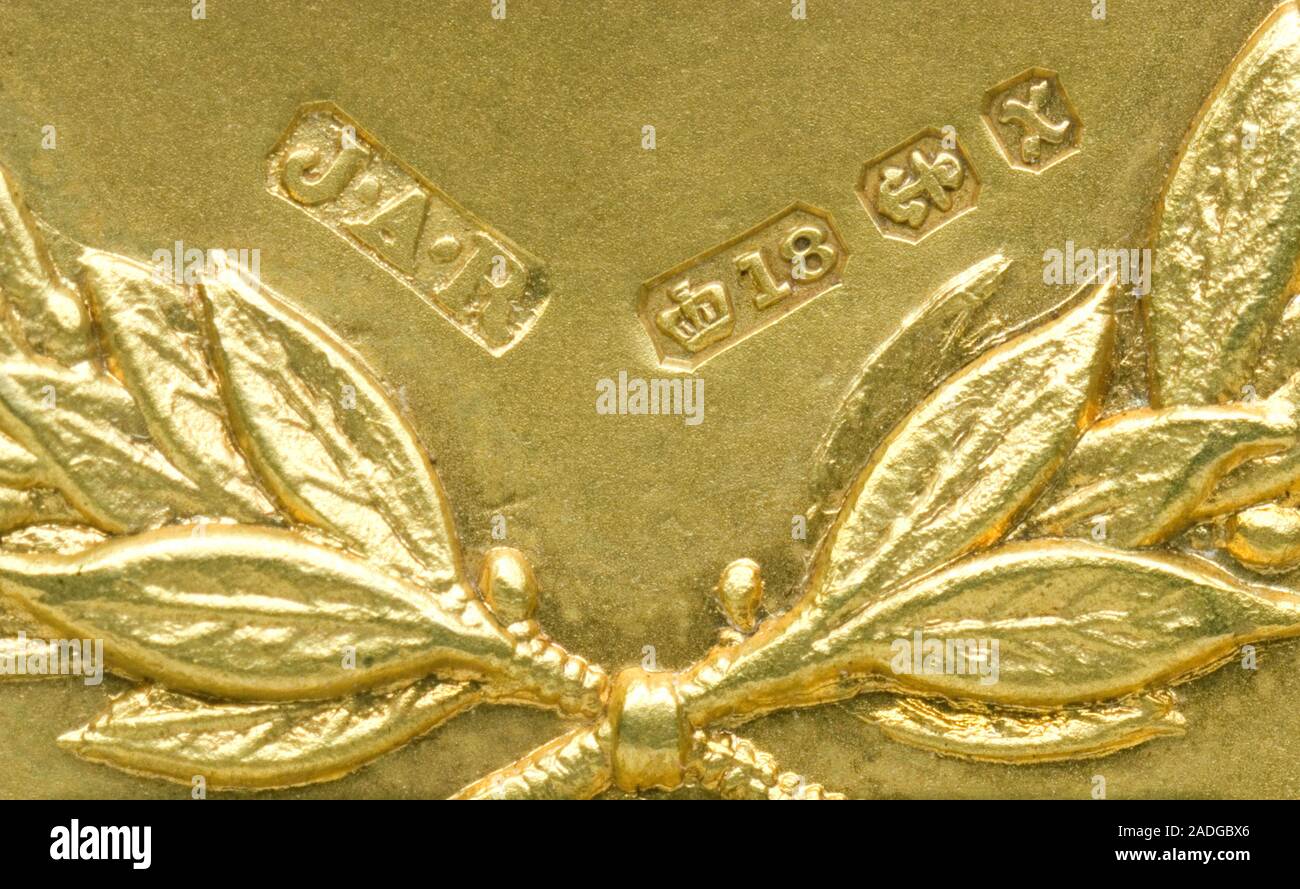 Gold hallmarks from 1897 on a gold medal. A hallmark is an official ...