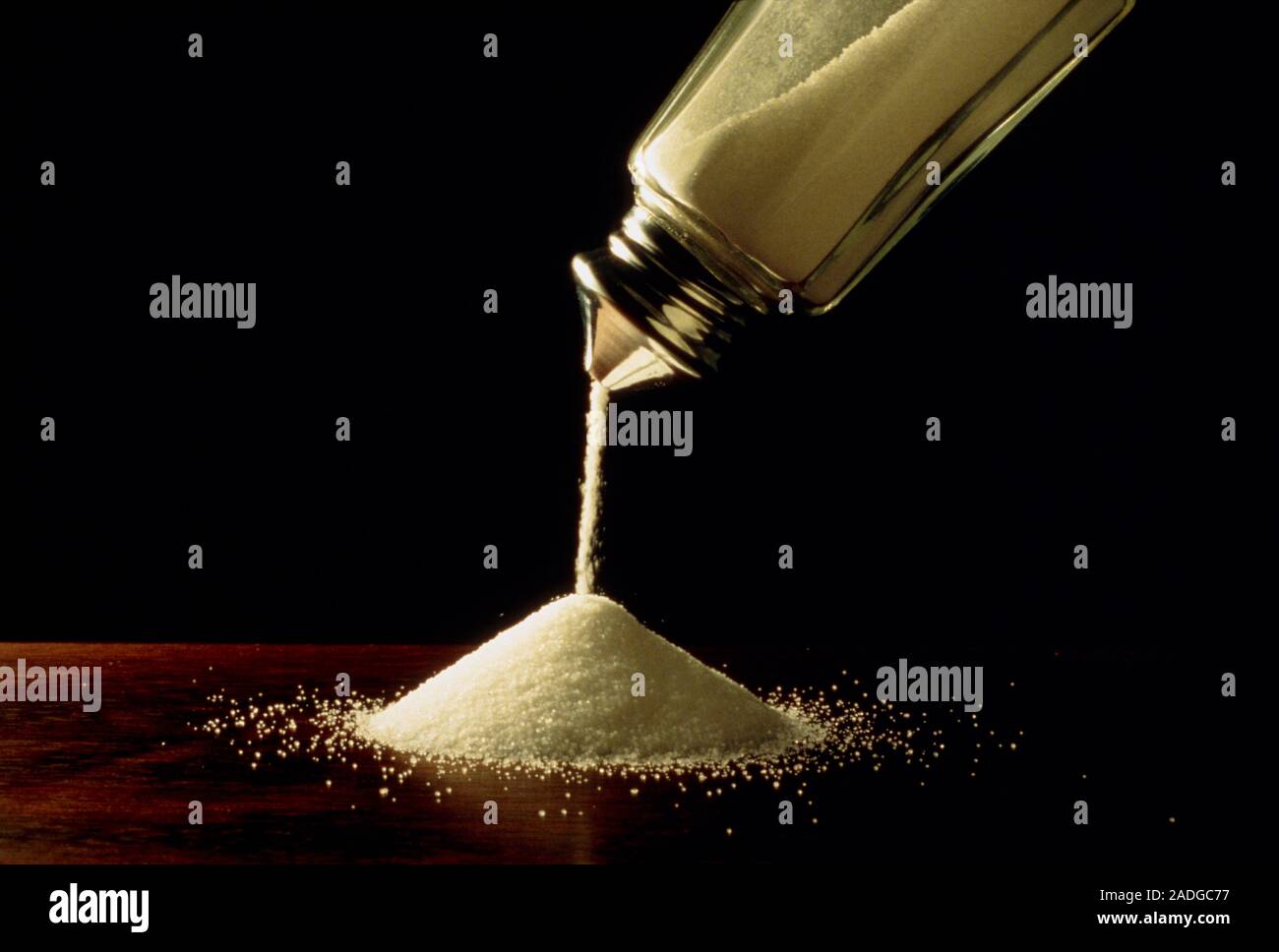 Salt. Ordinary table salt (sodium chloride) being poured from a salt ...