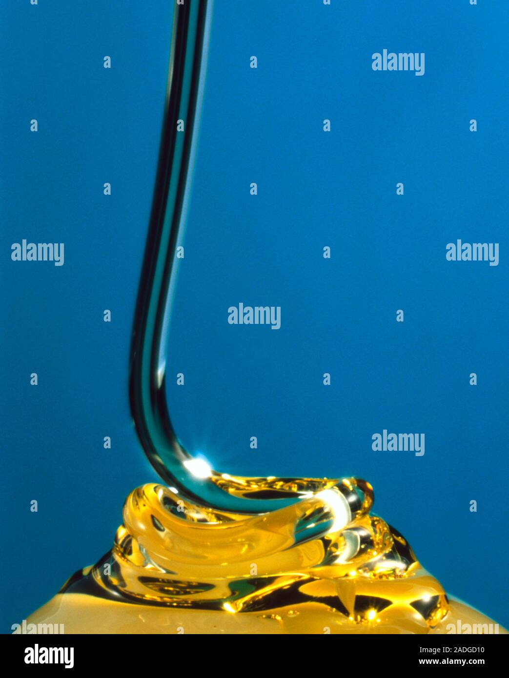 Pouring syrup. View of syrup coiling as it pours. This is due to the ...