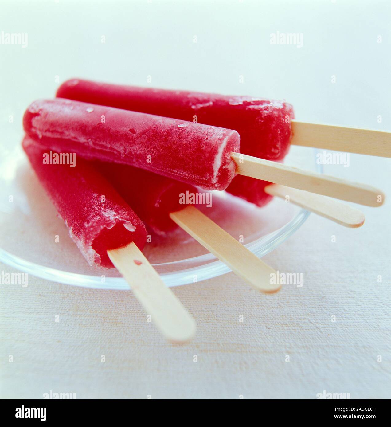 Iced lollies on a plate. These are flavoured ice shapes on sticks Stock ...