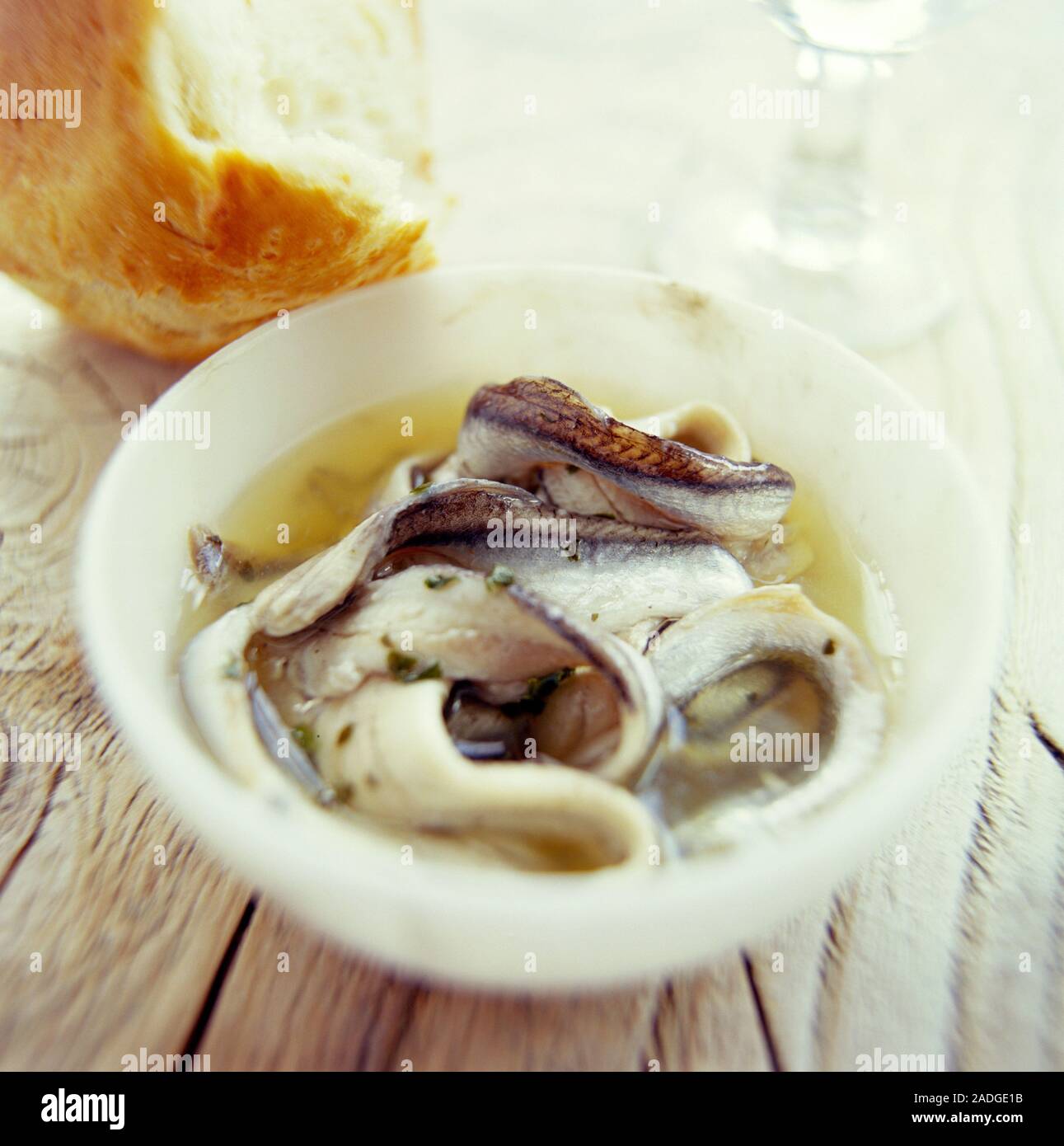 Fish and bread meal. Fish fillets in a bowl with a piece of bread ...