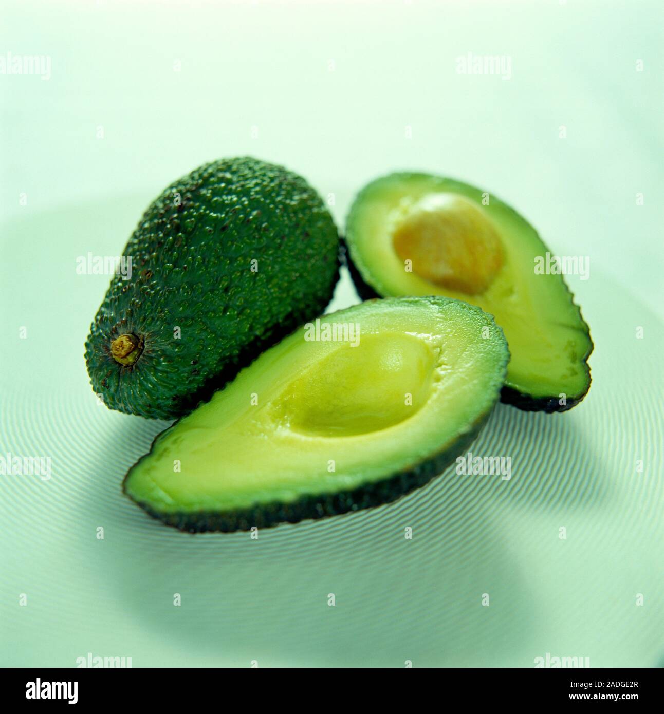 Avocados. Halved and whole avocados, the fruit of the avocado plant ...