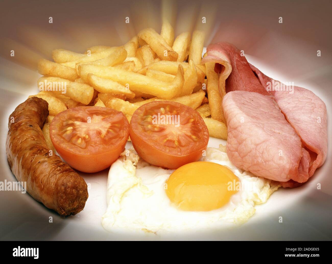 Fried meal comprising chips, tomato, sausage, egg and bacon. Fried food ...